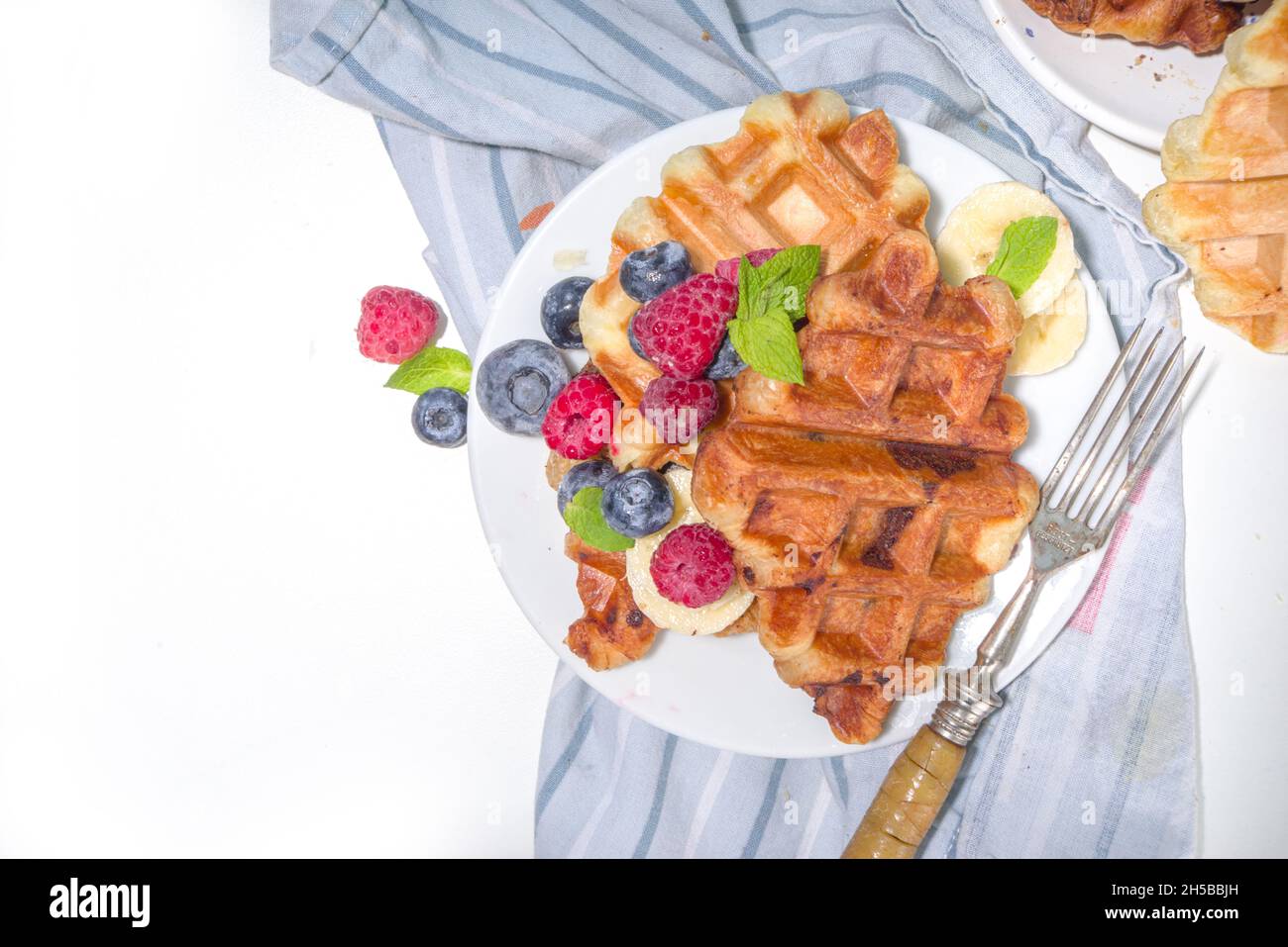 Modern dessert croffle - mixture of croissants and waffles, puff baking ...