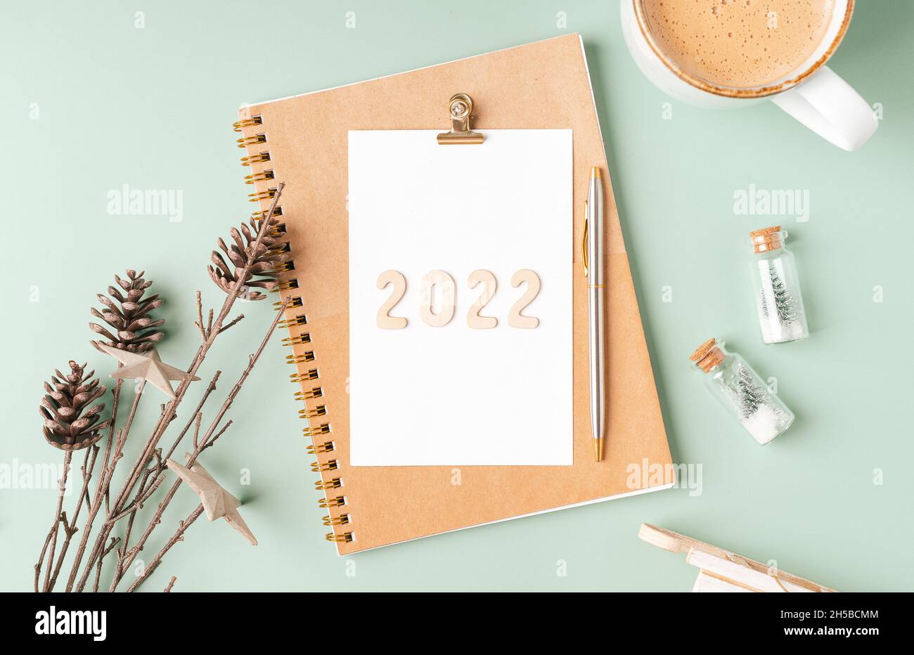 Top view Desktop Christmas notepad with 2022 text. Flat lay on green ...