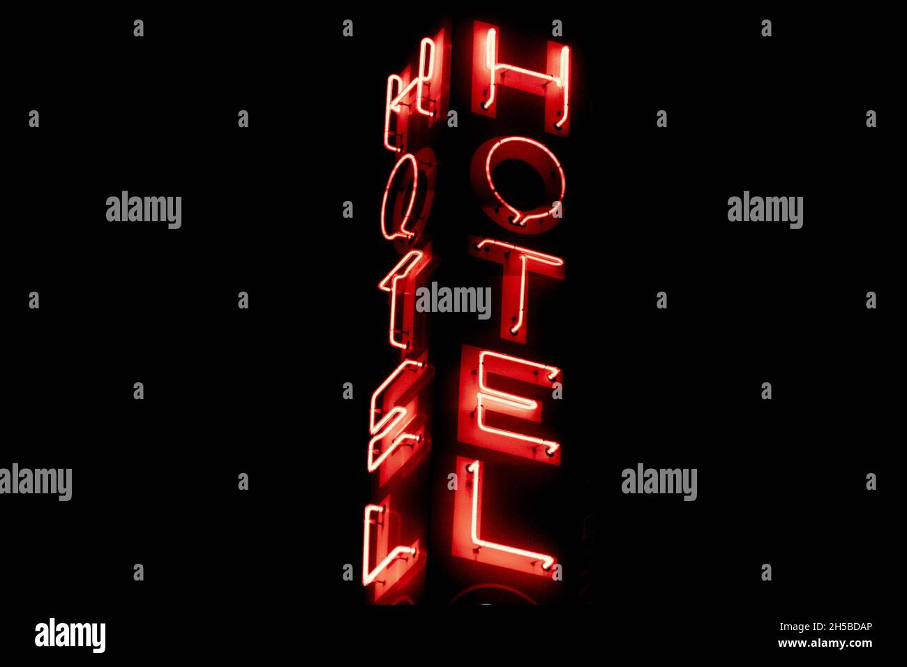 hotel neon red sign isolated on black background Stock Photo - Alamy