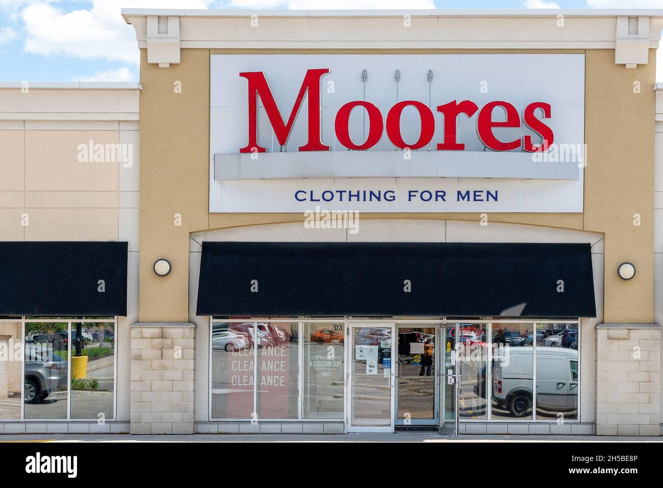 Entrance sign and facade of a Moores retail store specializing in ...