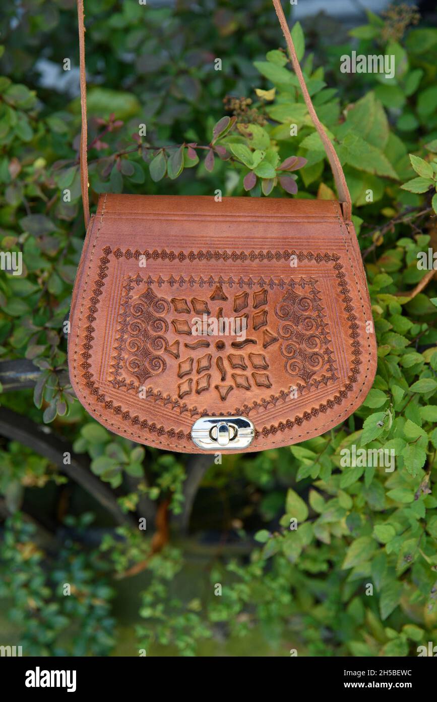 small yellow women's leather bag with a carved pattern Stock Photo - Alamy