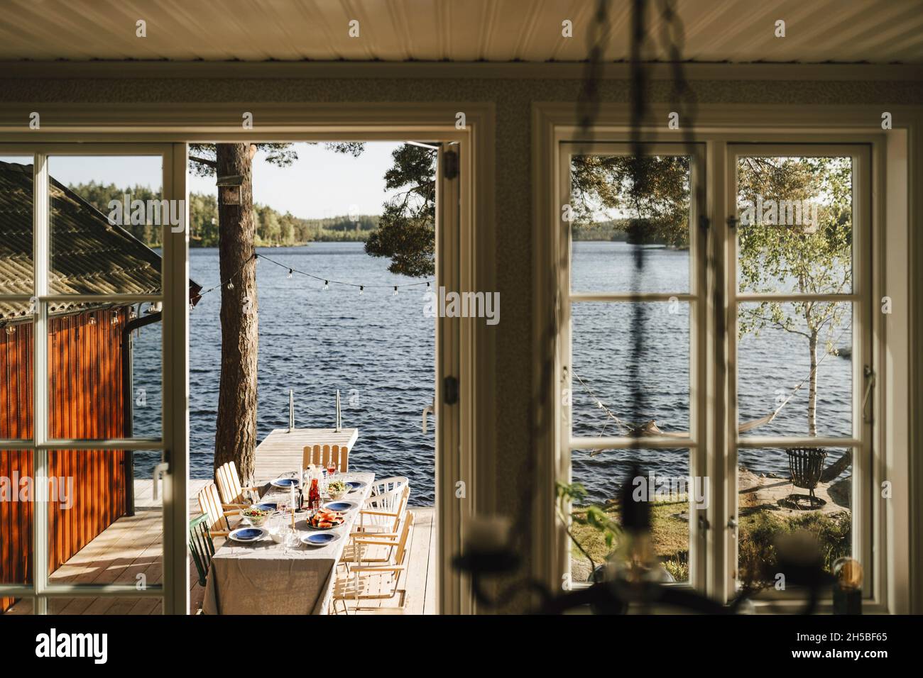 Dining table seen through window on sunny day Stock Photo - Alamy