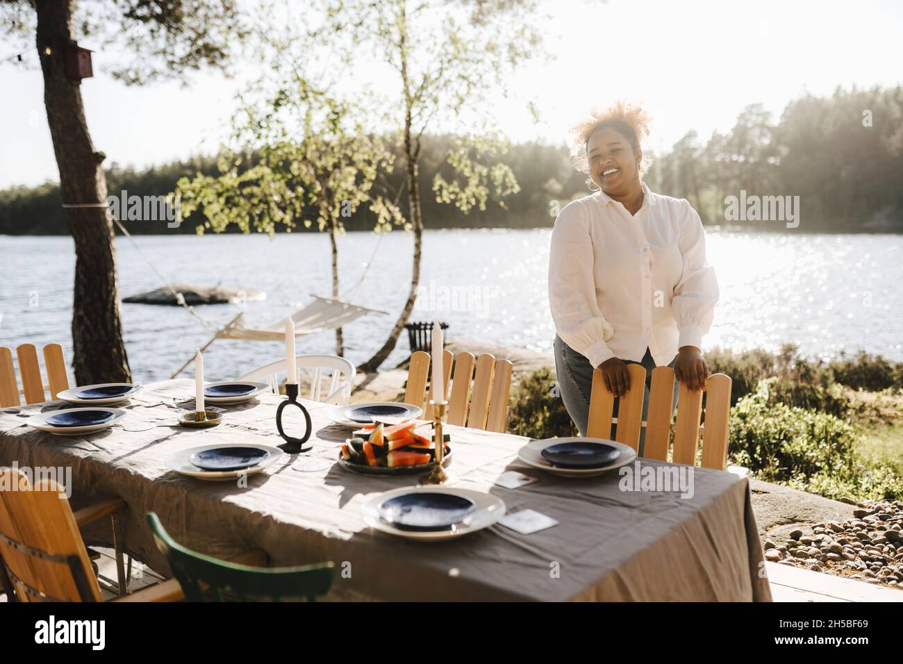 Happy woman standing table hi-res stock photography and images - Alamy