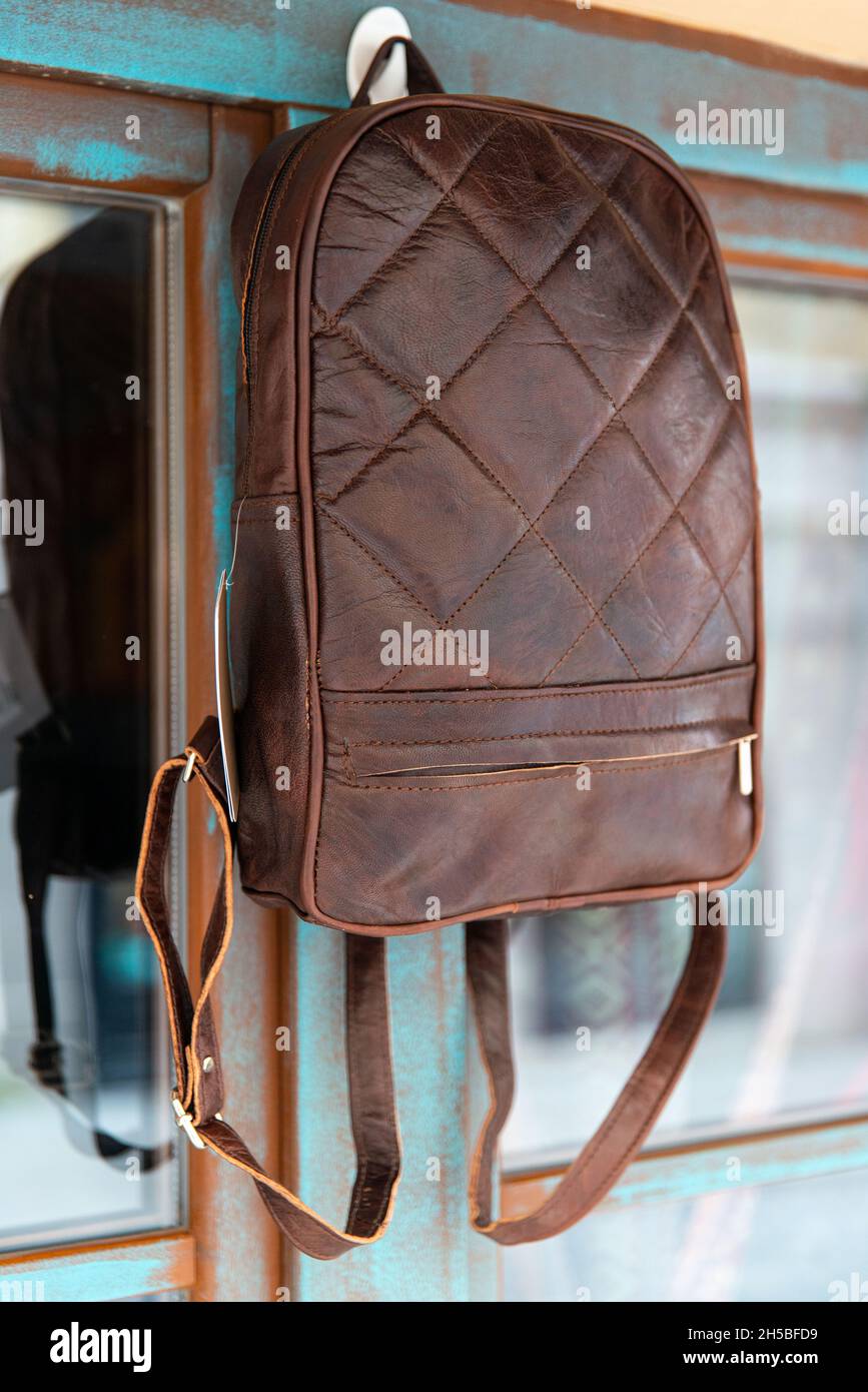 Brown leather backpack on the window Stock Photo - Alamy
