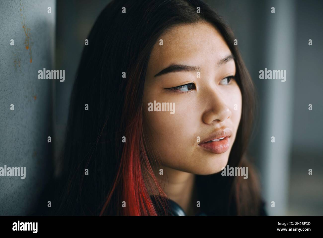 Teenage girl contemplating while looking away Stock Photo - Alamy