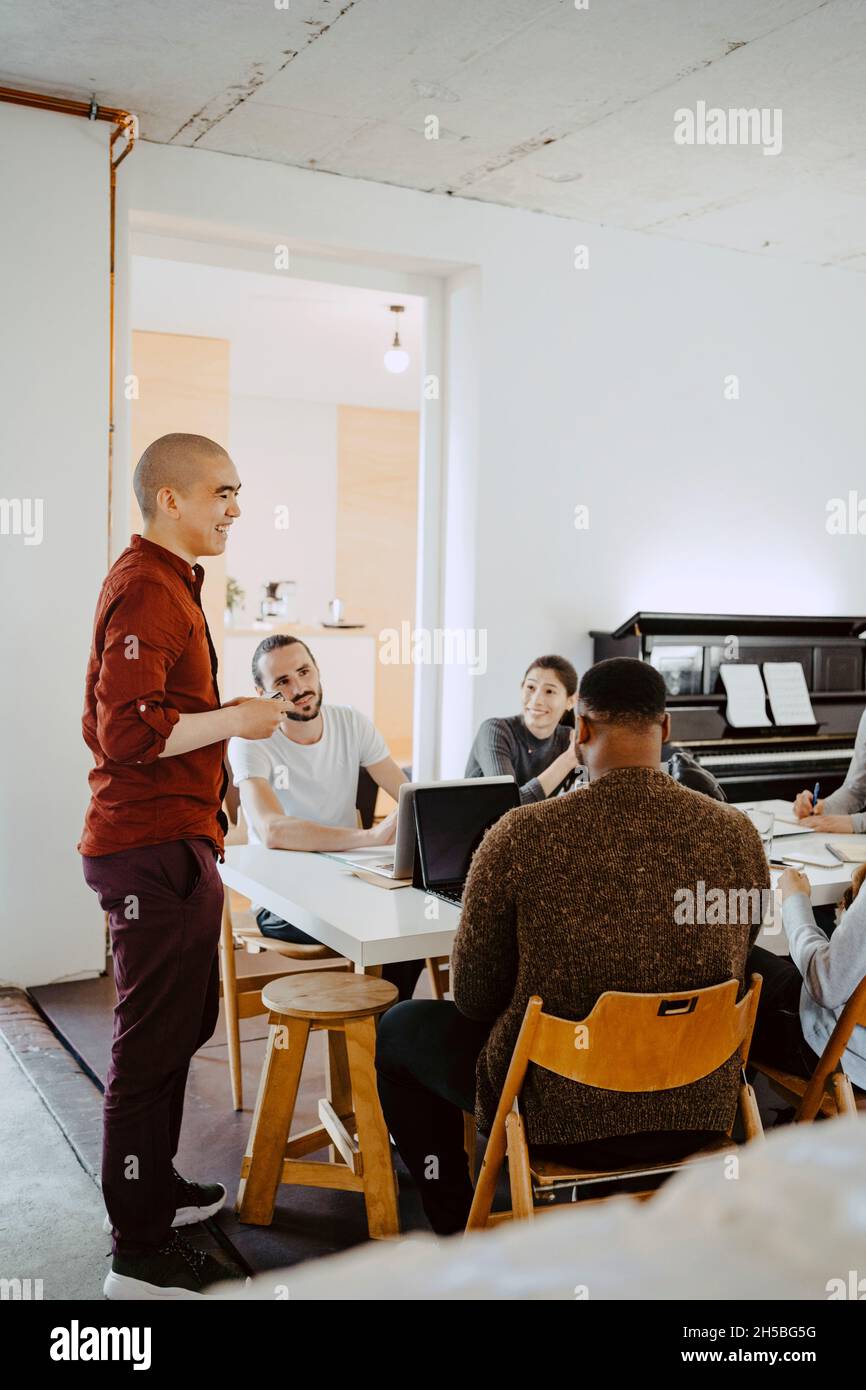 Male hacker presenting business idea during meeting at startup company ...