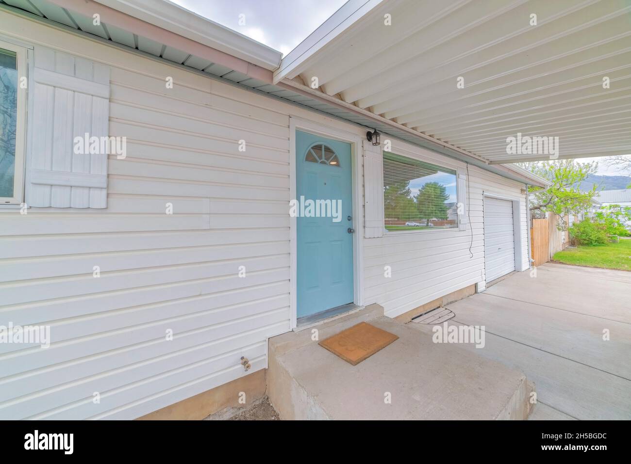 Concrete doorstep of a house with light blue front door Stock Photo - Alamy