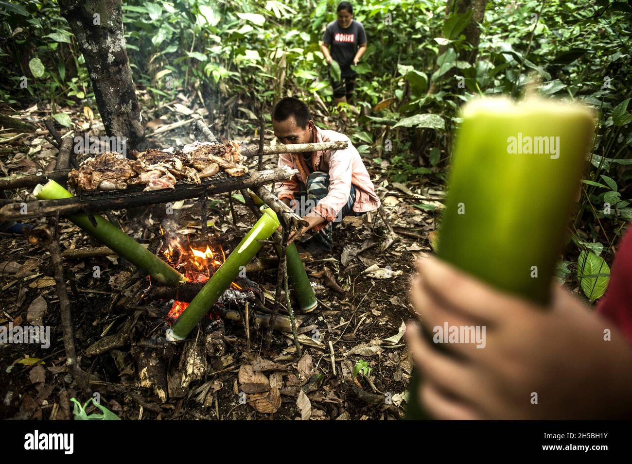 A Dayak family seen cooking with natural tools at they plantation area ...