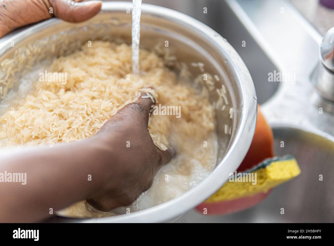 African American Nigerian woman washing rice before cooking Stock Photo ...