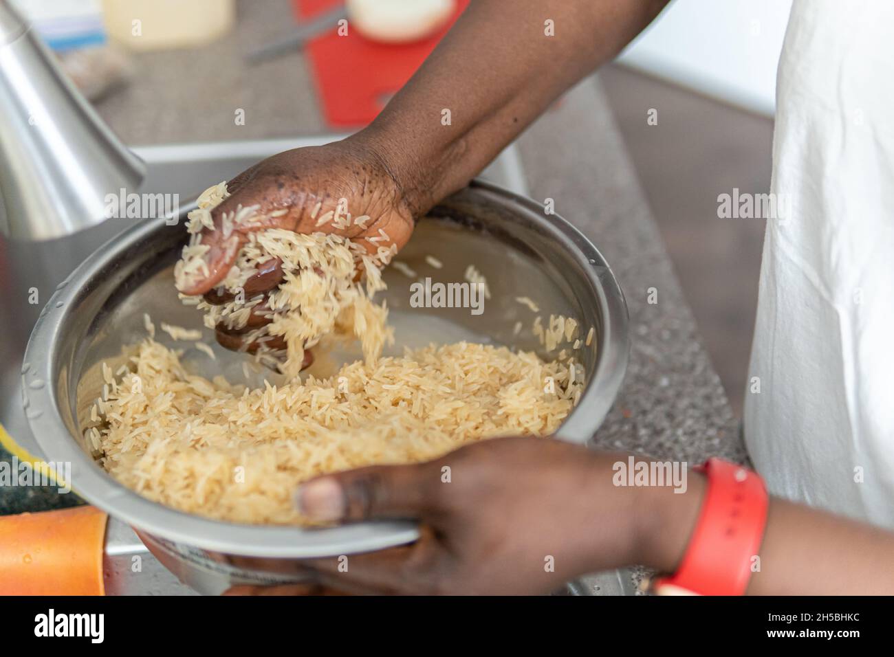 African American Nigerian woman washing rice before cooking Stock Photo ...