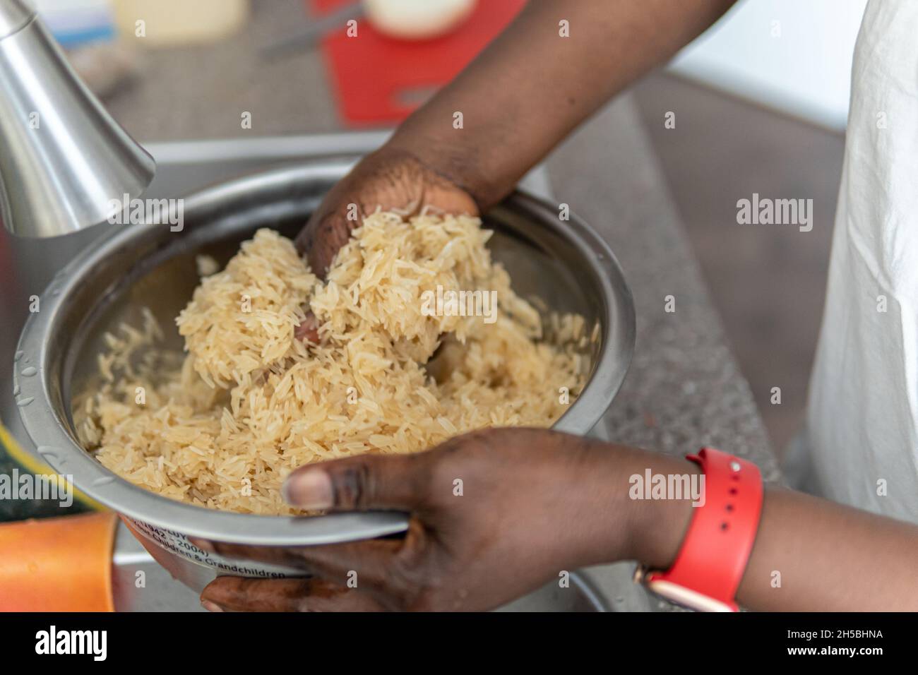African American Nigerian woman washing rice before cooking Stock Photo ...