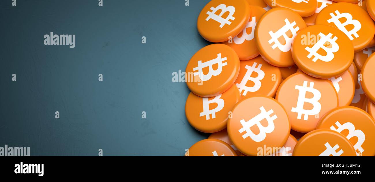 Logos of the cryptocurrency Bitcoin (BTC) on a heap on a table. Copy ...