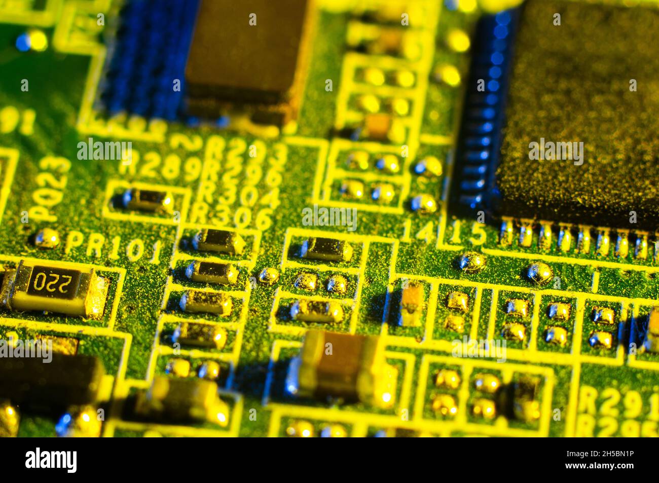 Old electronic circuit board close up in macro photography, yellow ...