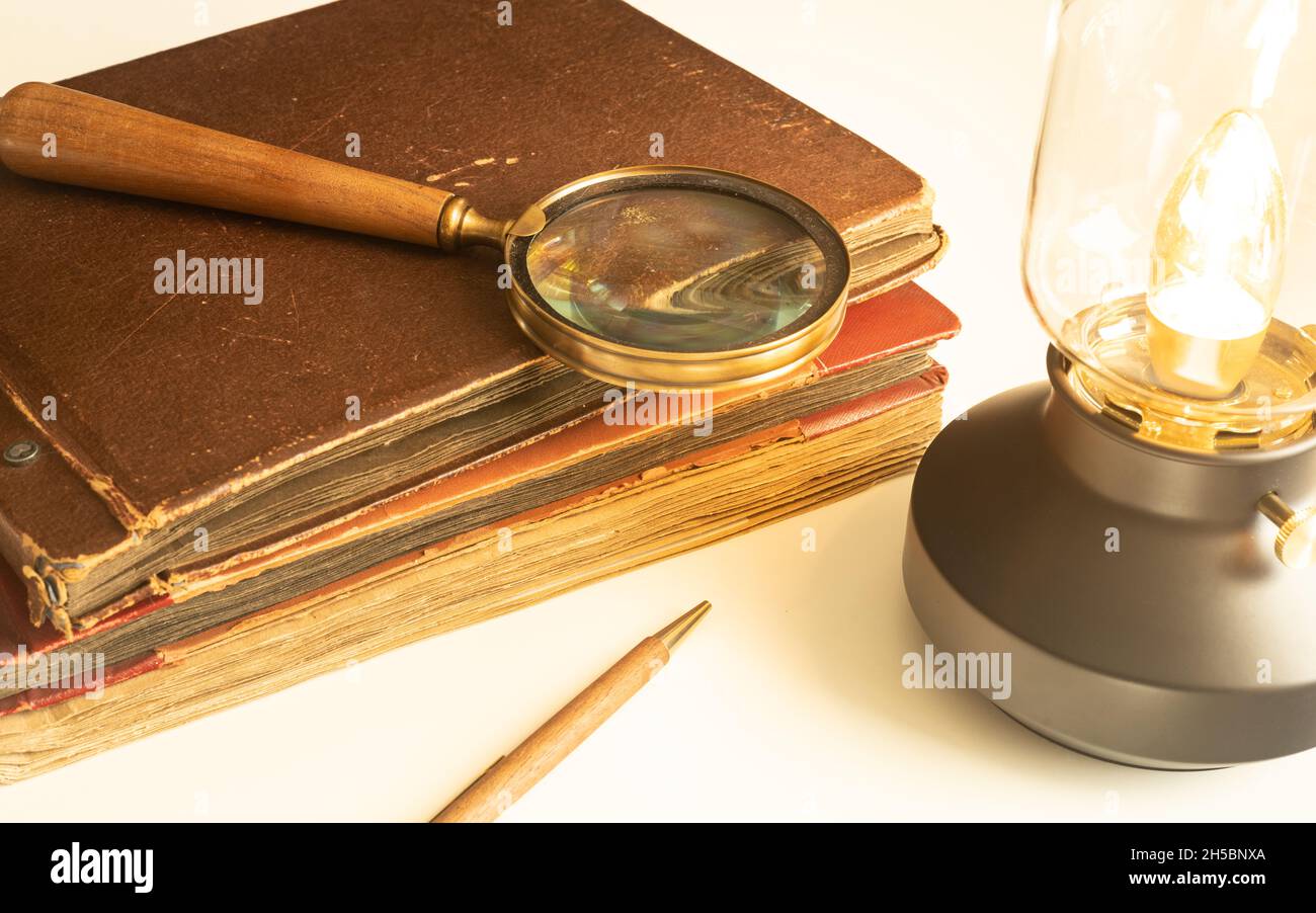 Old photo albums and a vintage-style glowing lamp. Concept of family ...