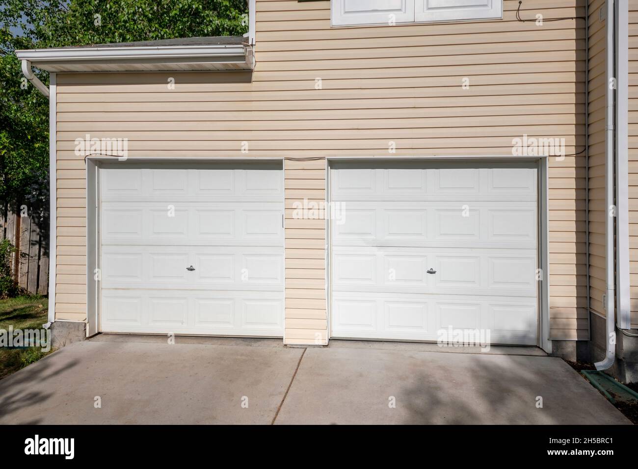 Attached double garage of a house with white sectional doors Stock ...