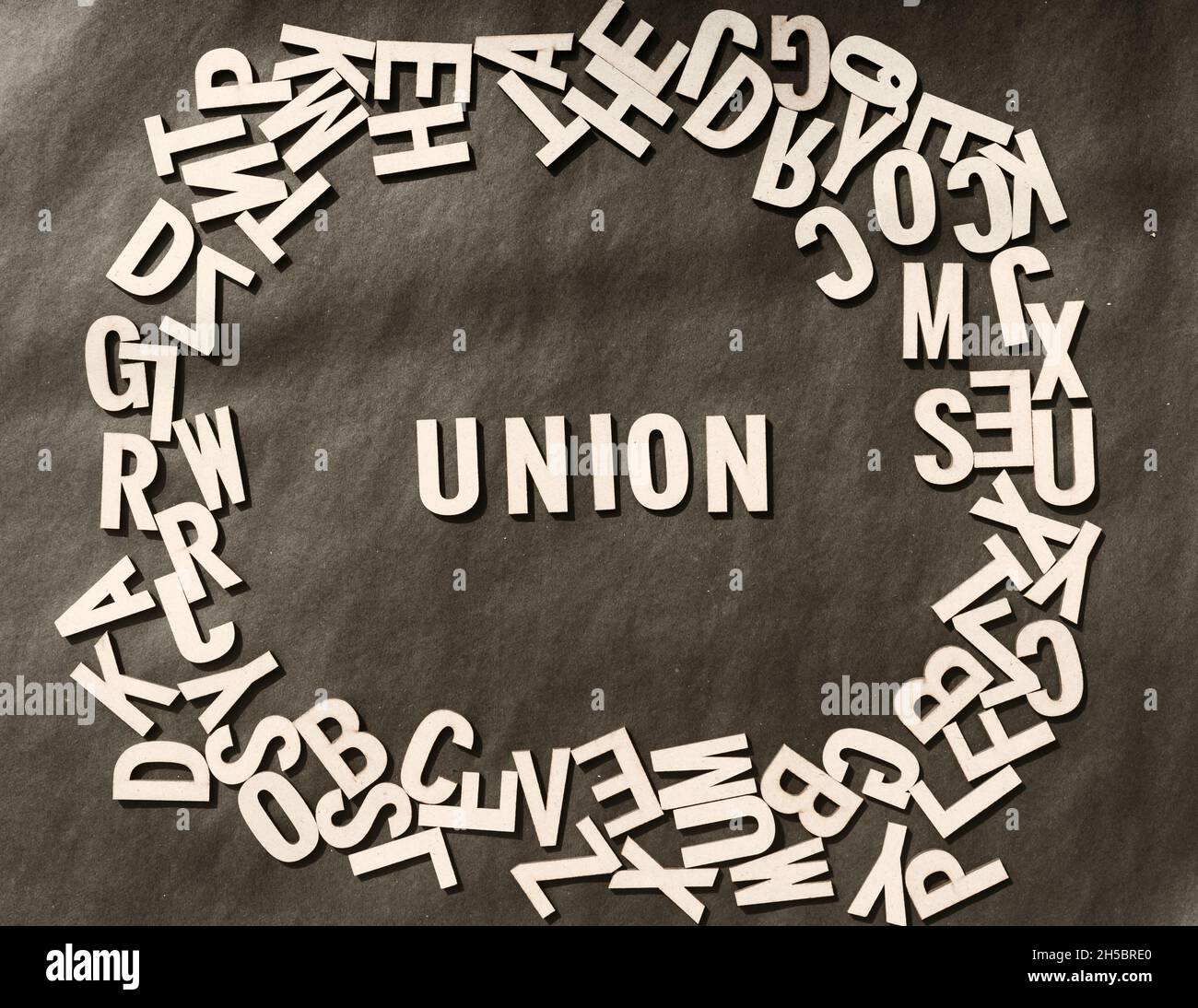 Union Word In Wooden Cube Alphabet Letters Top View On A rustic paper ...