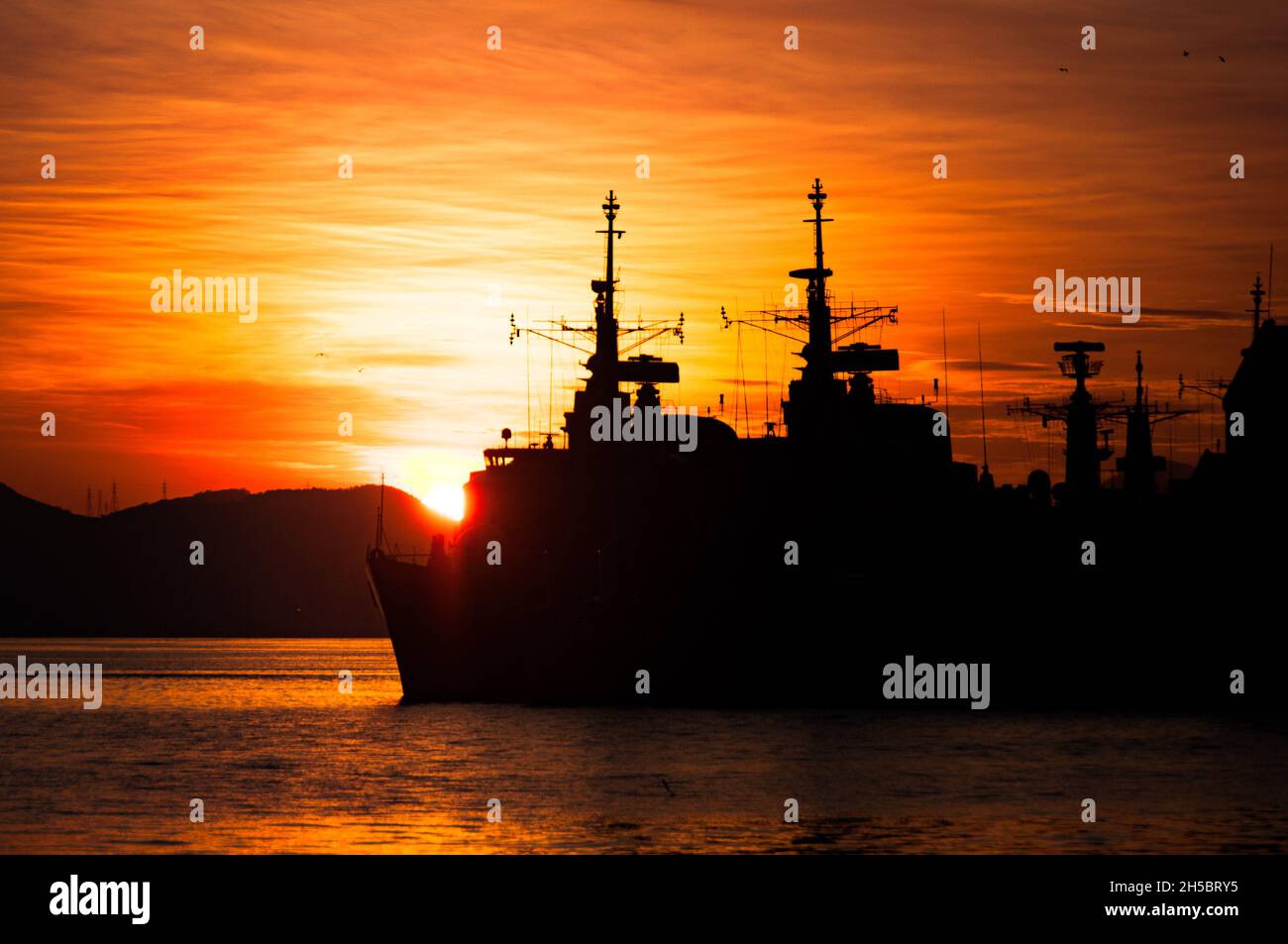Military Navy Ships Silhouettes by Sunset Stock Photo - Alamy