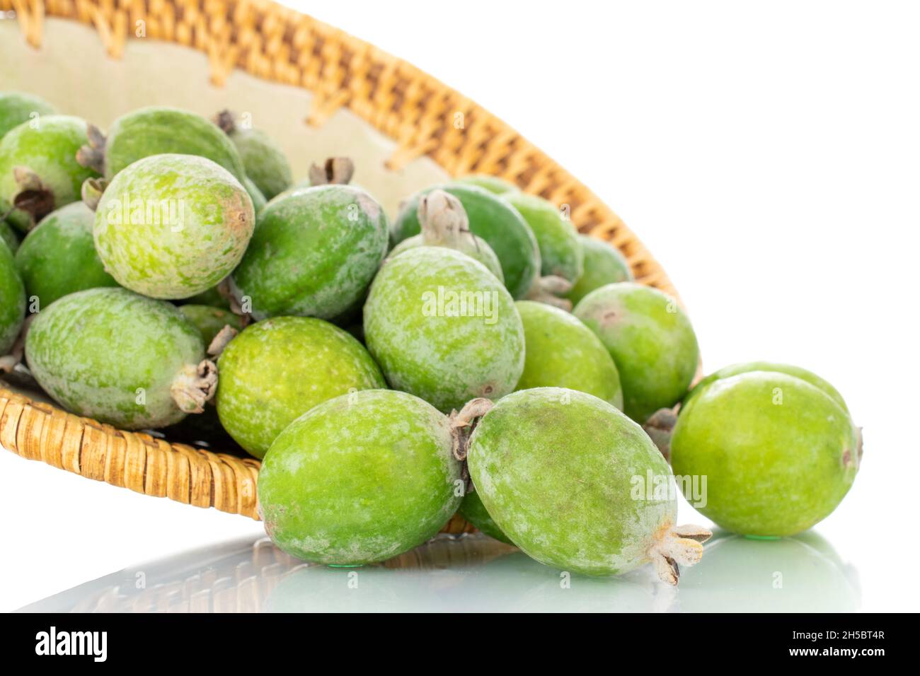 Several ripe sweet feijoa fruits with a ceramic plate, close-up ...