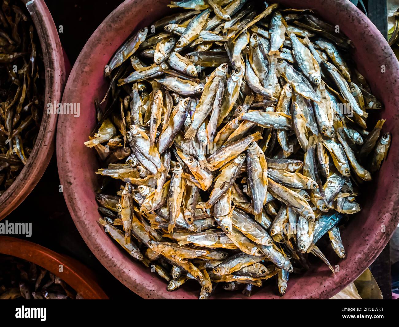 Dried fish on basket in market. The salted dried fish is hung on by the ...