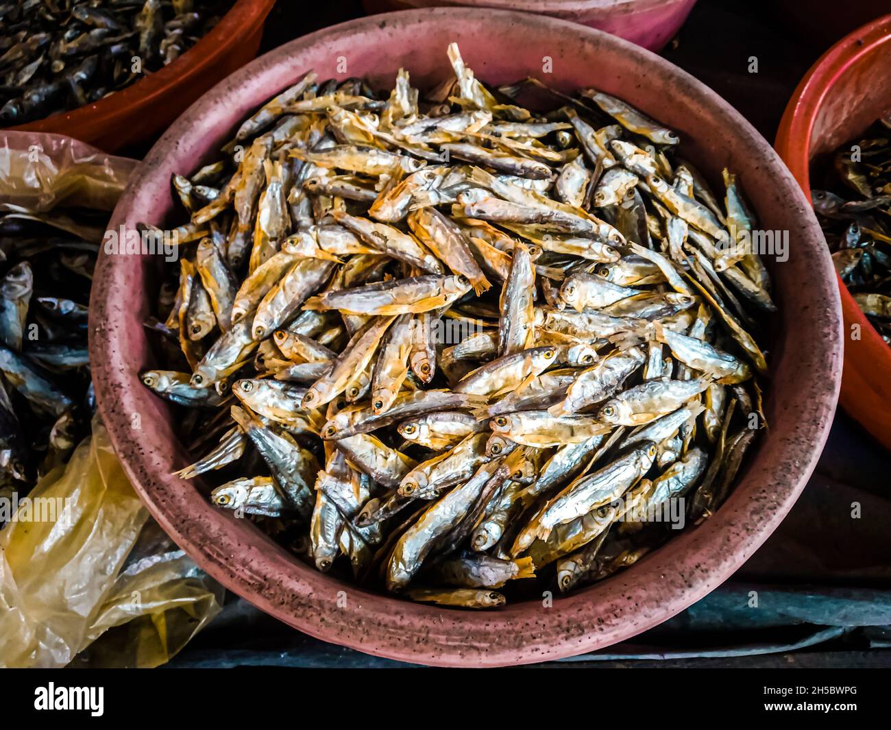 Dried fish on basket in market. The salted dried fish is hung on by the ...