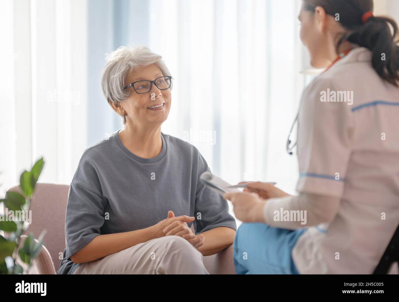 Female patient listening to a doctor in hospital Stock Photo - Alamy