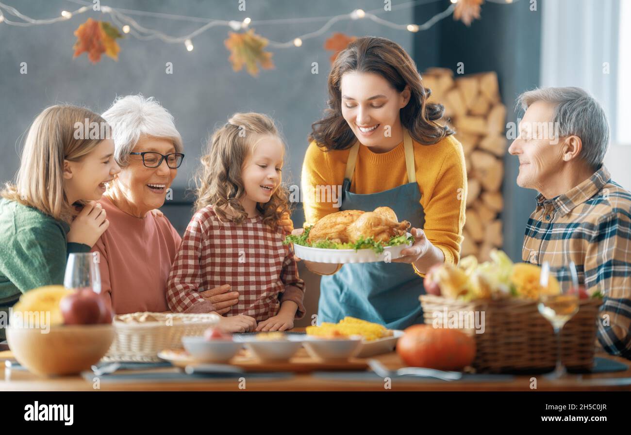 Thanksgiving Day, Autumn feast. Happy family sitting at the table and ...