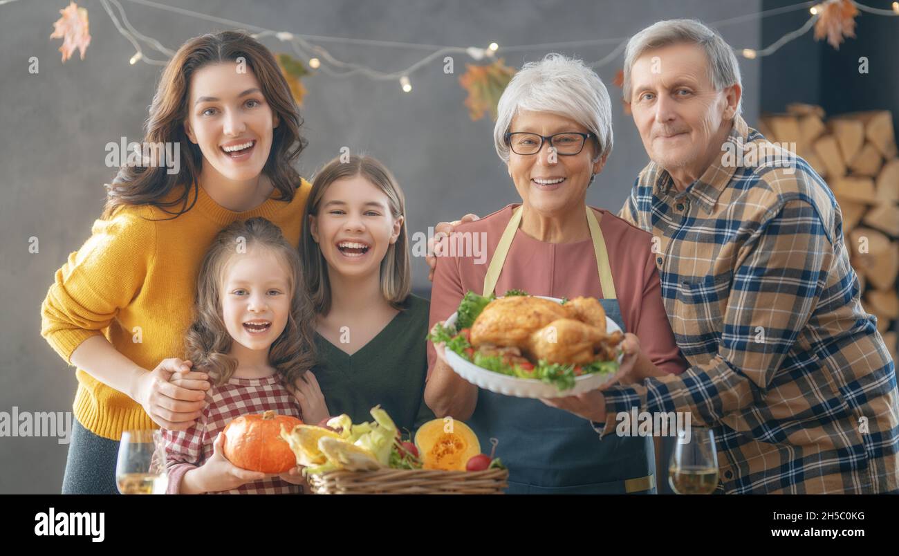 Thanksgiving Day, Autumn feast. Happy family sitting at the table and ...