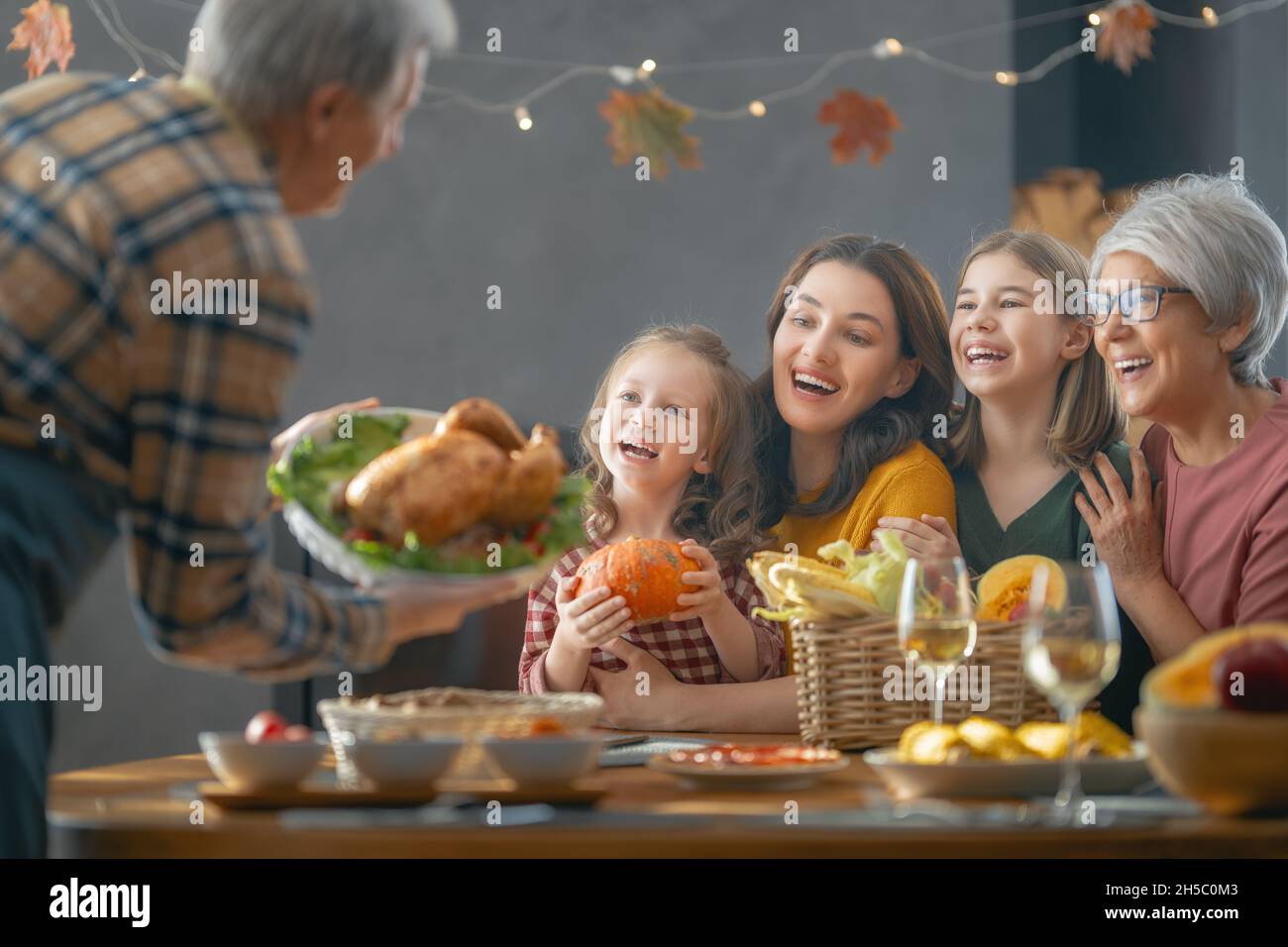 Thanksgiving Day, Autumn feast. Happy family sitting at the table and ...