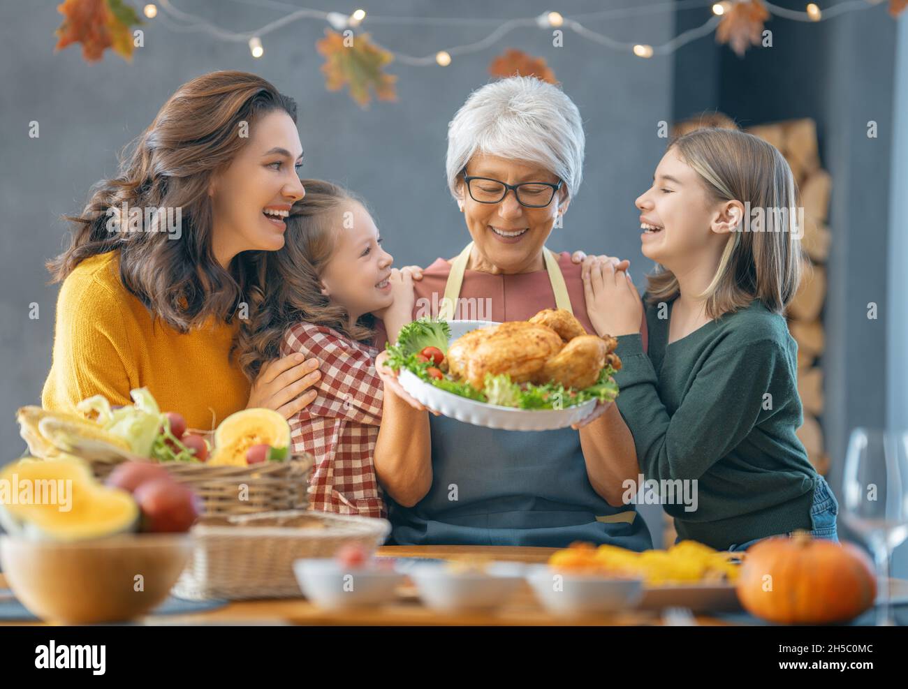 Thanksgiving Day, Autumn feast. Happy family sitting at the table and ...
