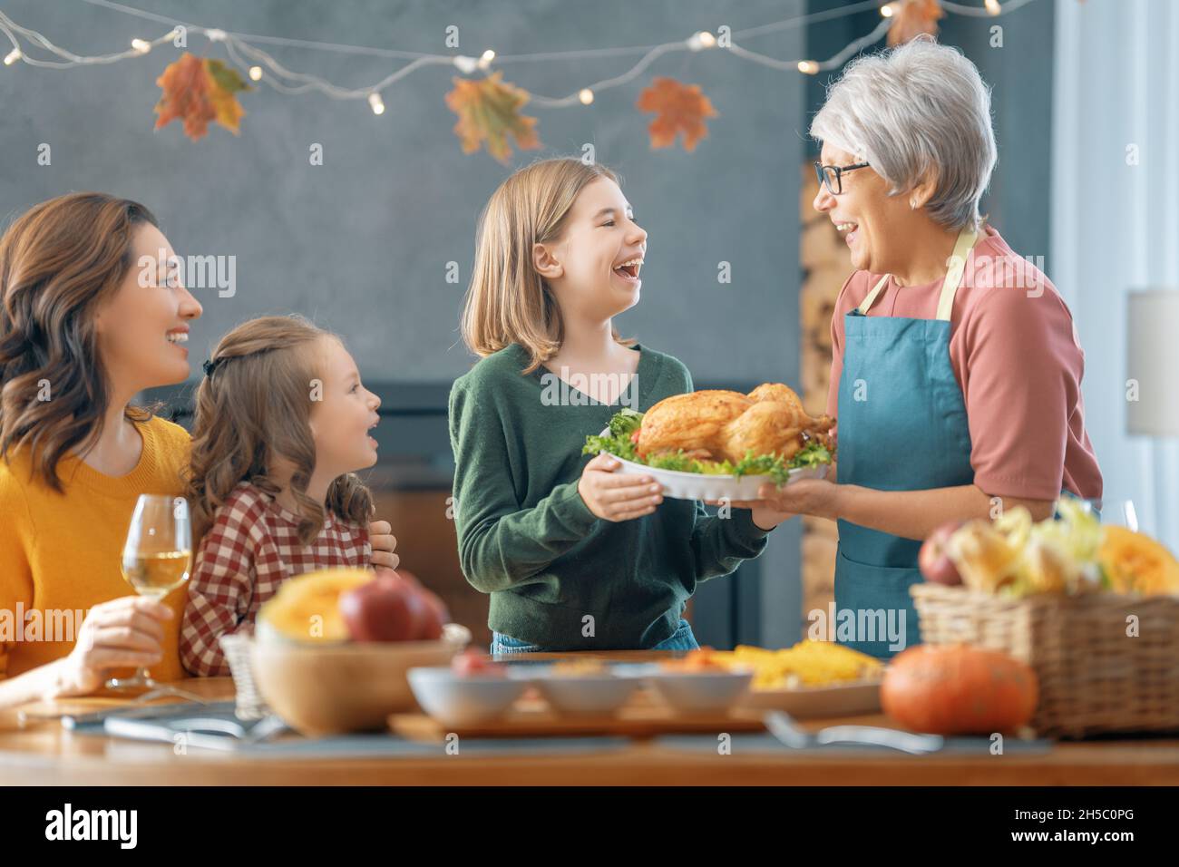 Thanksgiving Day, Autumn feast. Happy family sitting at the table and ...