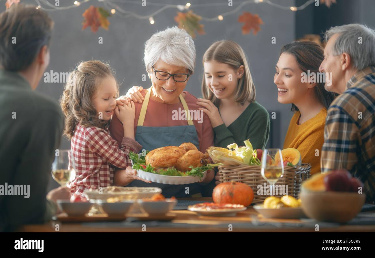 Thanksgiving Day, Autumn feast. Happy family sitting at the table and ...