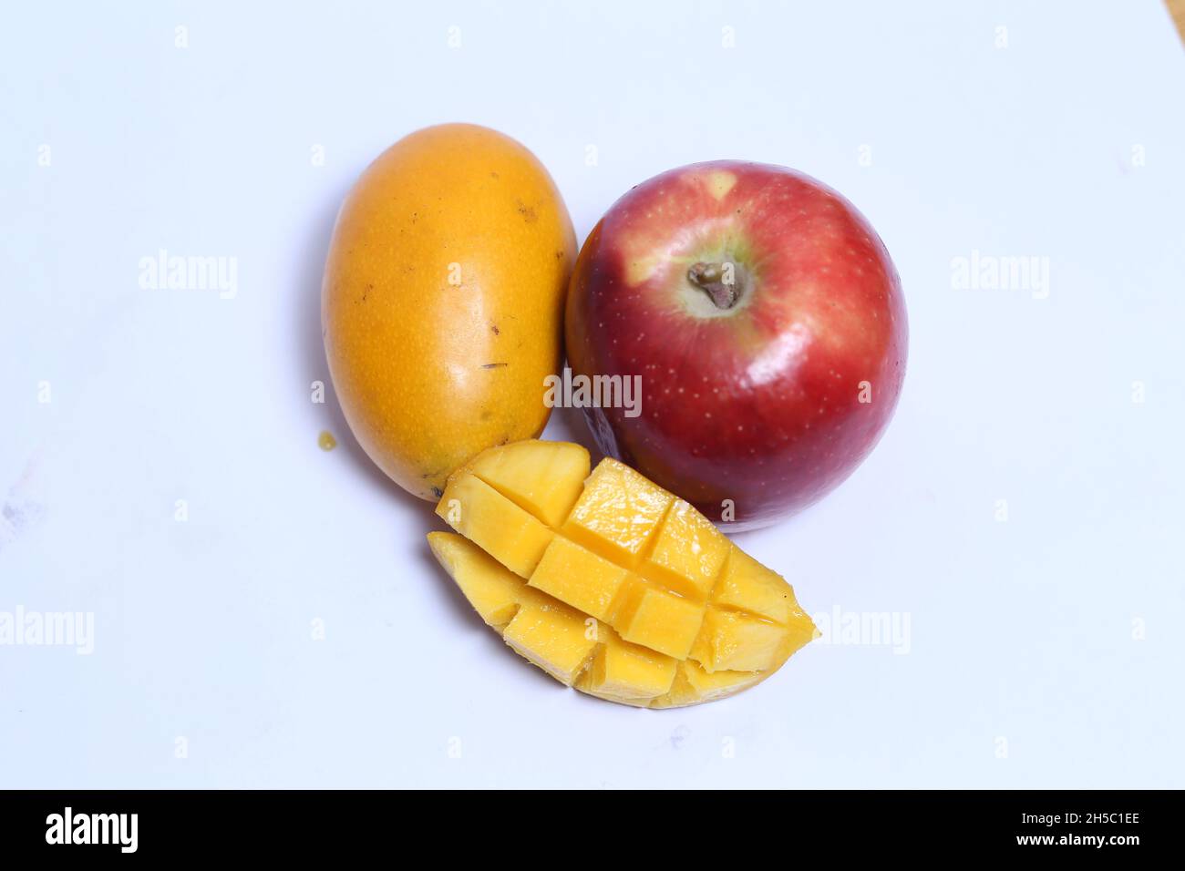 Apple and mangos isolated on white background Stock Photo - Alamy