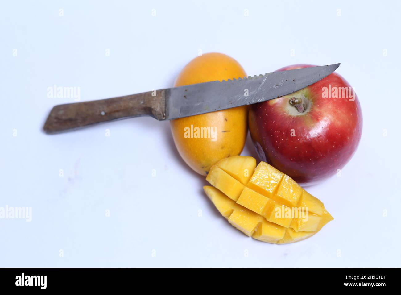 Apple, mango and a knife isolated on white background Stock Photo - Alamy