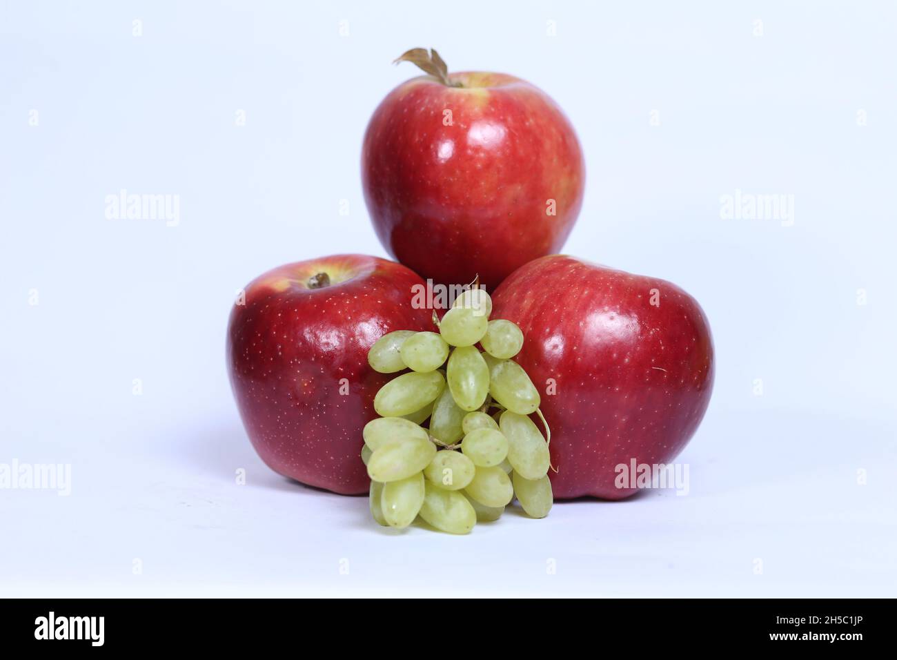 Red apples and grape isolated on white background Stock Photo - Alamy