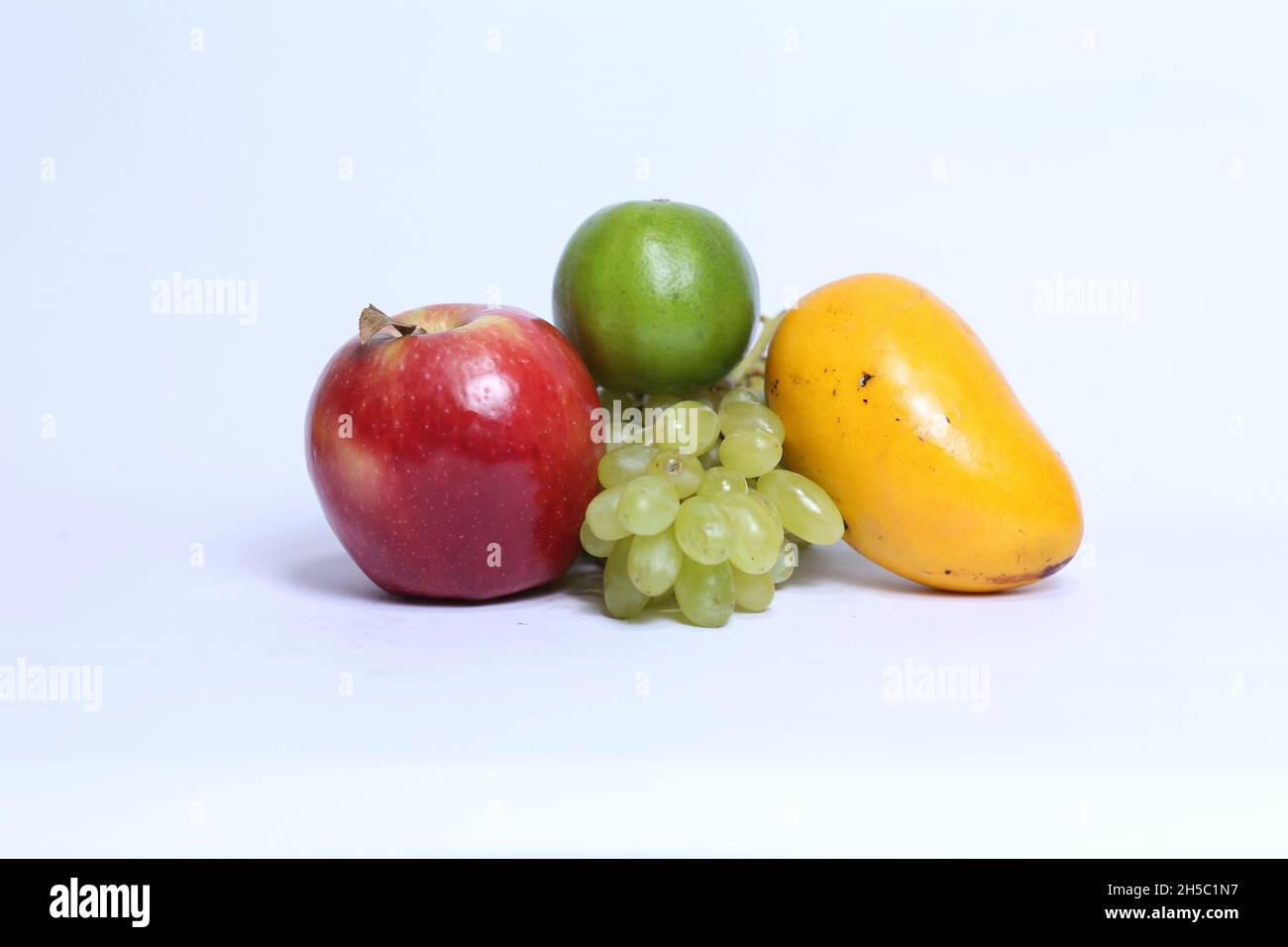 Citrus limetta, grapes, mango and apple isolated on white background ...