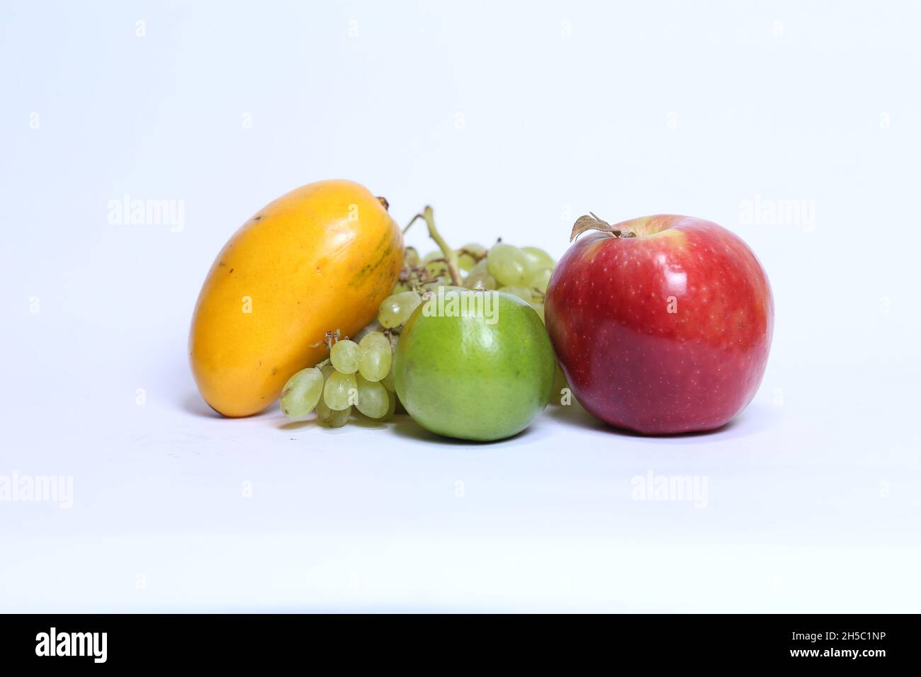 Citrus limetta, grapes, mango and grapes isolated on white background ...