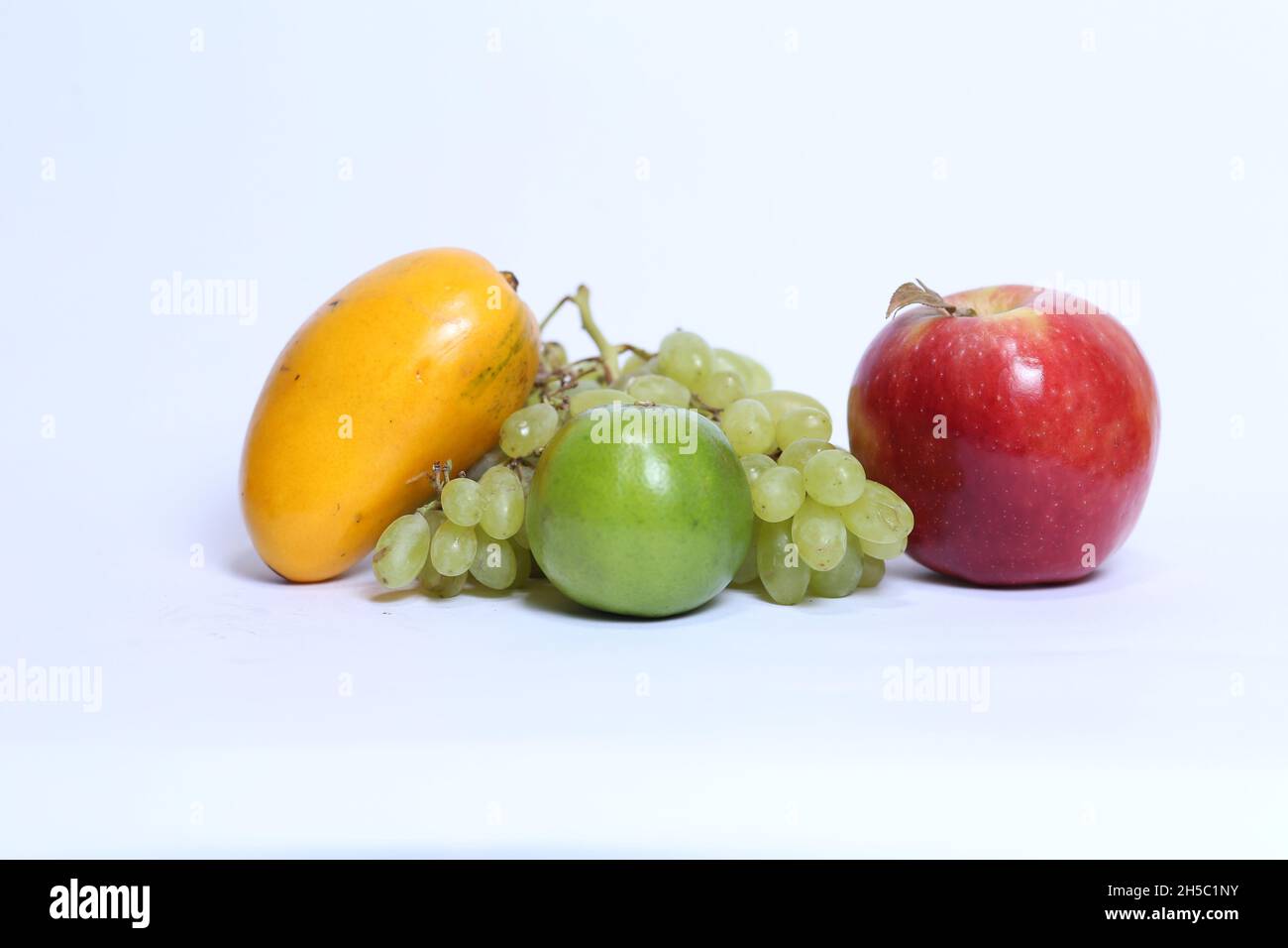 Citrus limetta, grapes, mango and apple isolated on white background ...