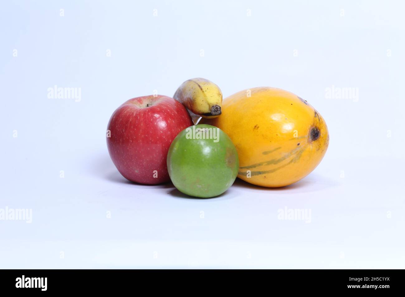 Citrus limetta, apple, banana and mango isolated on white background ...
