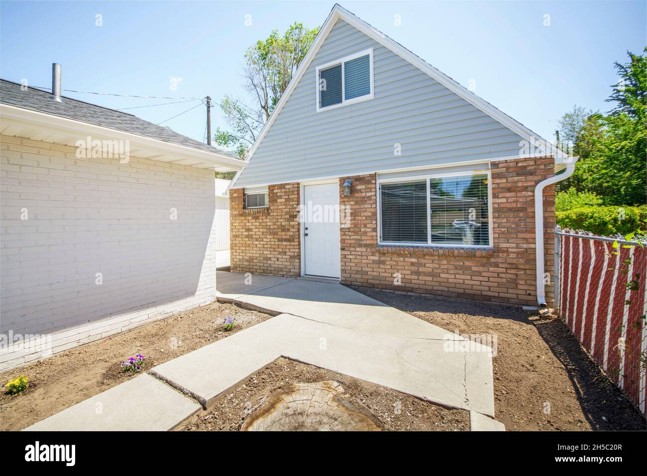 Guest house exterior with vinyl wood and bricks siding Stock Photo - Alamy