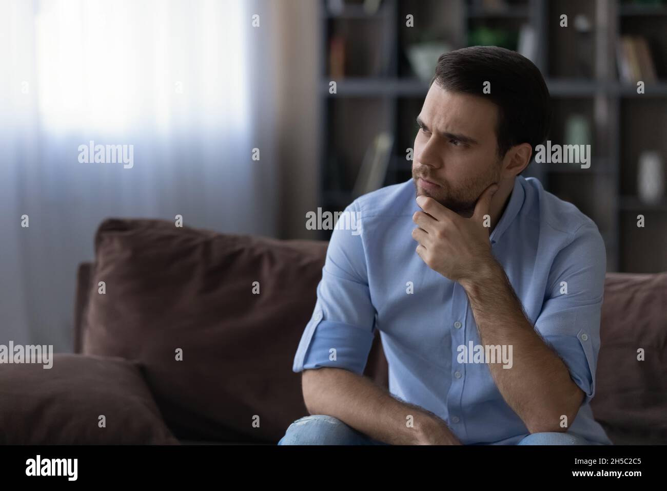 Confused stressed young man looking in distance Stock Photo - Alamy