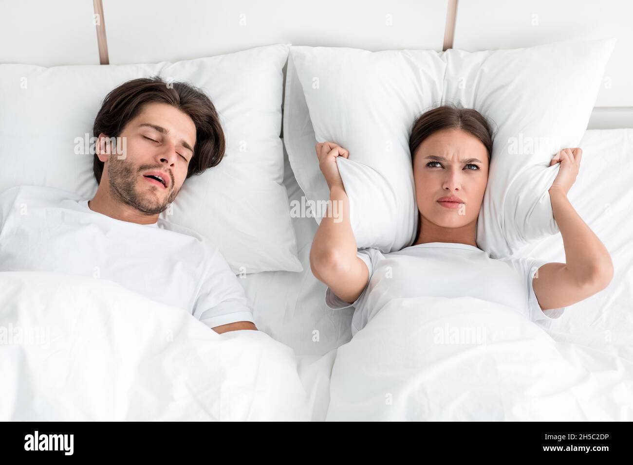 Attractive Millennial European Guy With Stubble Sleeps On Bed Angry