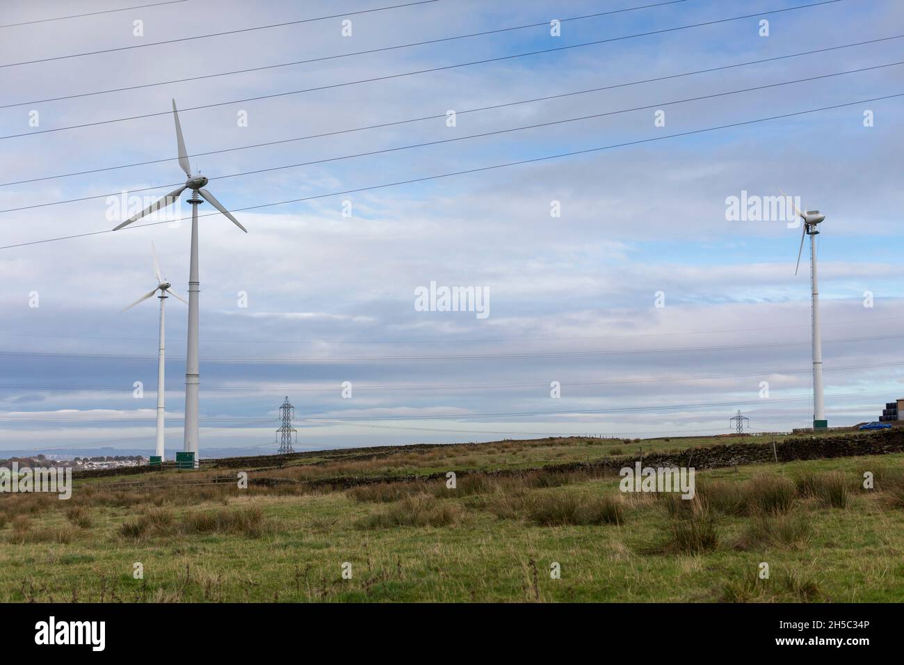 Windmills and pylons on the moors near Queensbury, West Yorkshire, UK ...