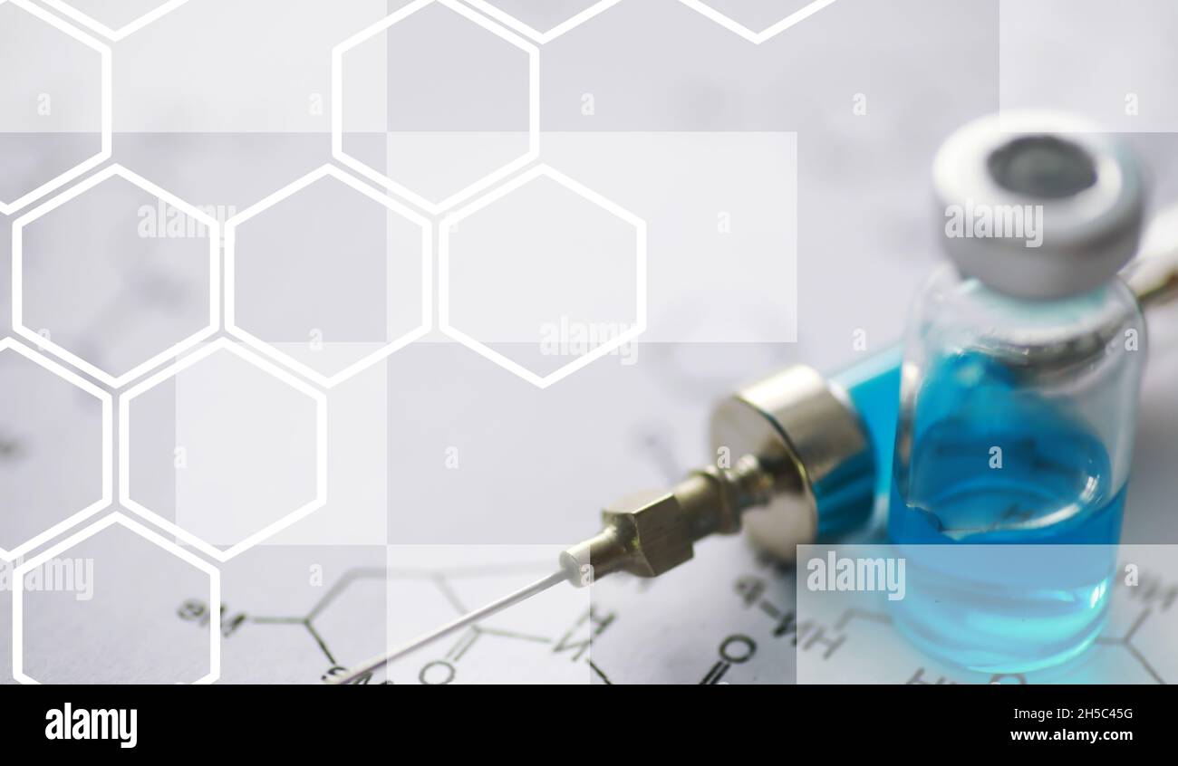 small jars with injection and syringe for injection on blue background ...