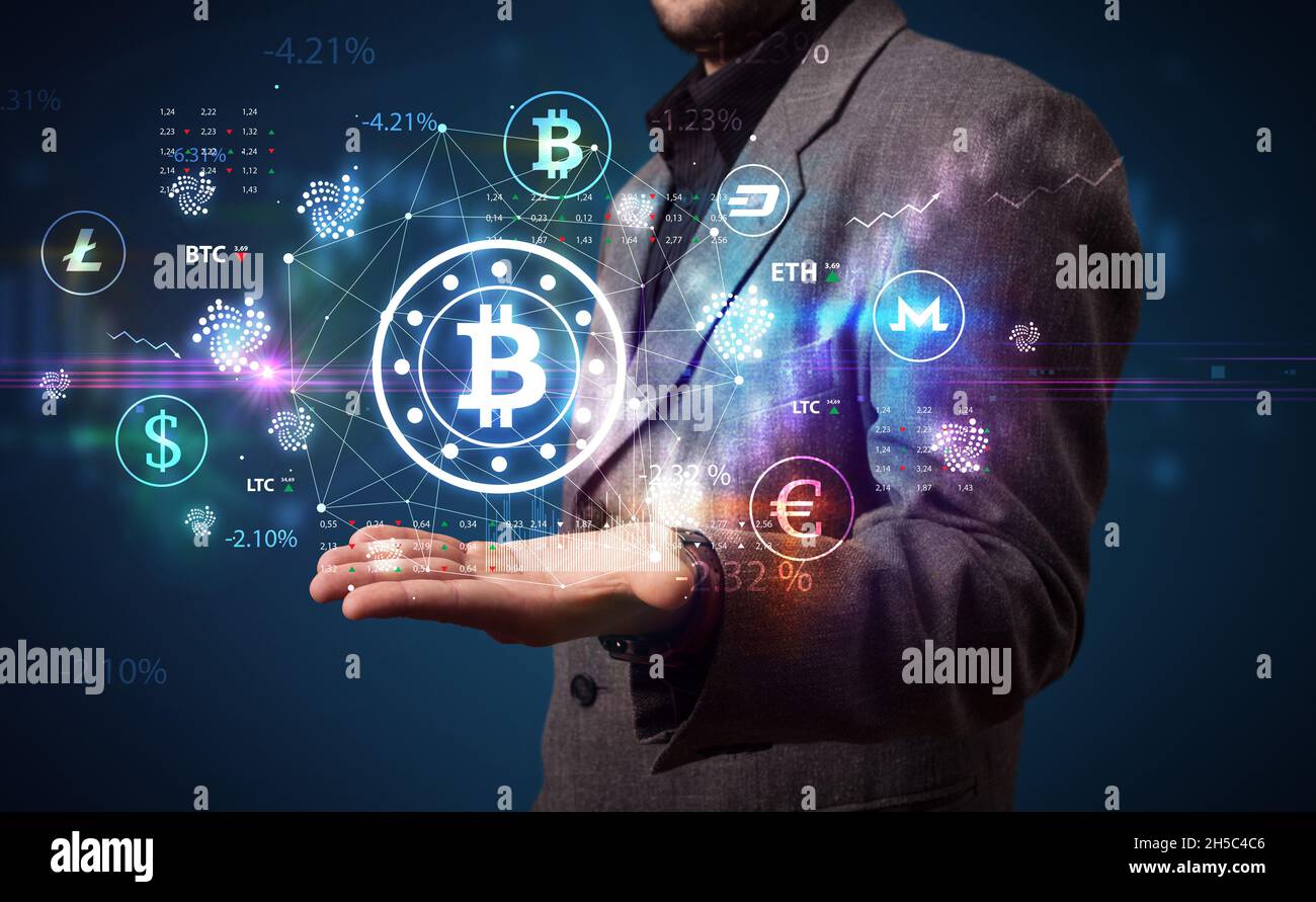 Businessman holding currency symbols concept Stock Photo - Alamy