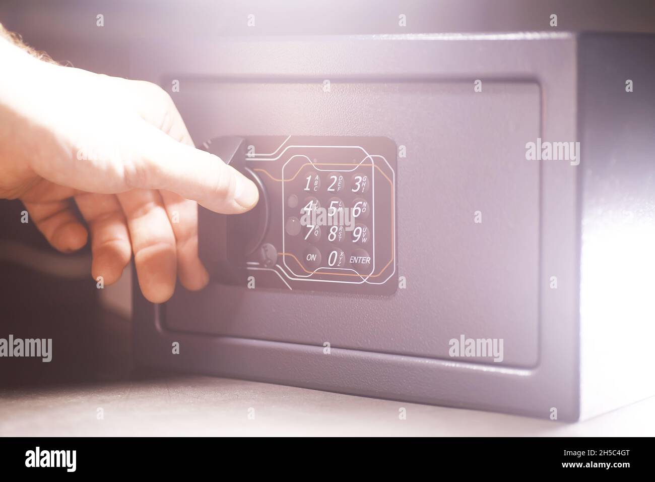 Steel safe with money. Hand putting password in the safety money box in ...