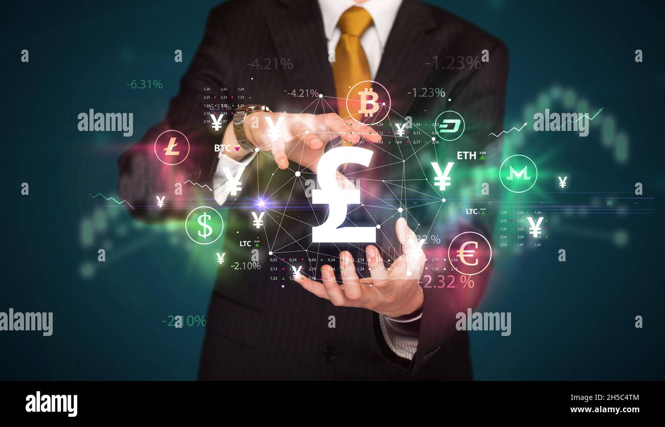 Businessman holding currency symbols concept Stock Photo - Alamy