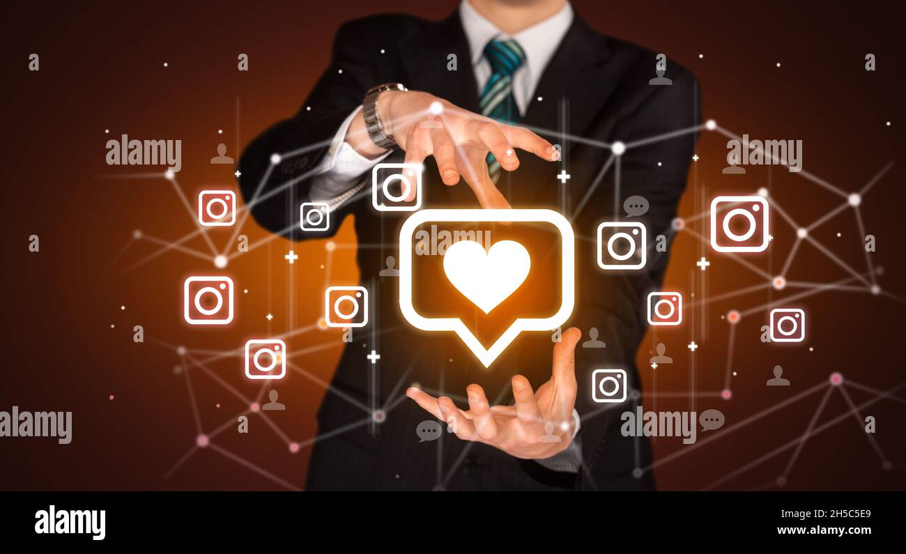 Hand holding social media icons Stock Photo - Alamy