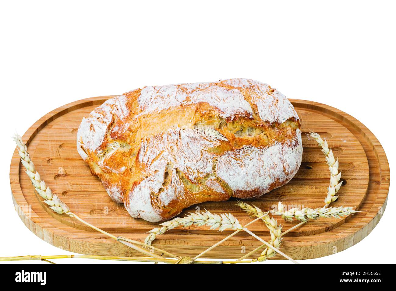 Close up view of whole grain loaf white bread and wheat ears on a ...
