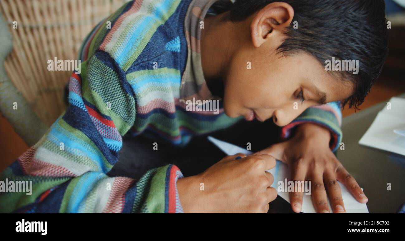 Portrait of a South Asian kid drawing Stock Photo - Alamy