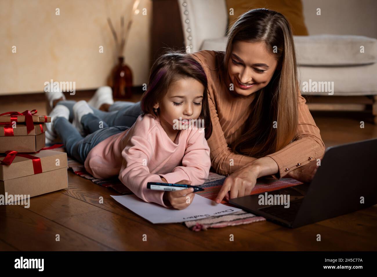 Portrait of happy woman and daughter writing letter to Santa Stock ...